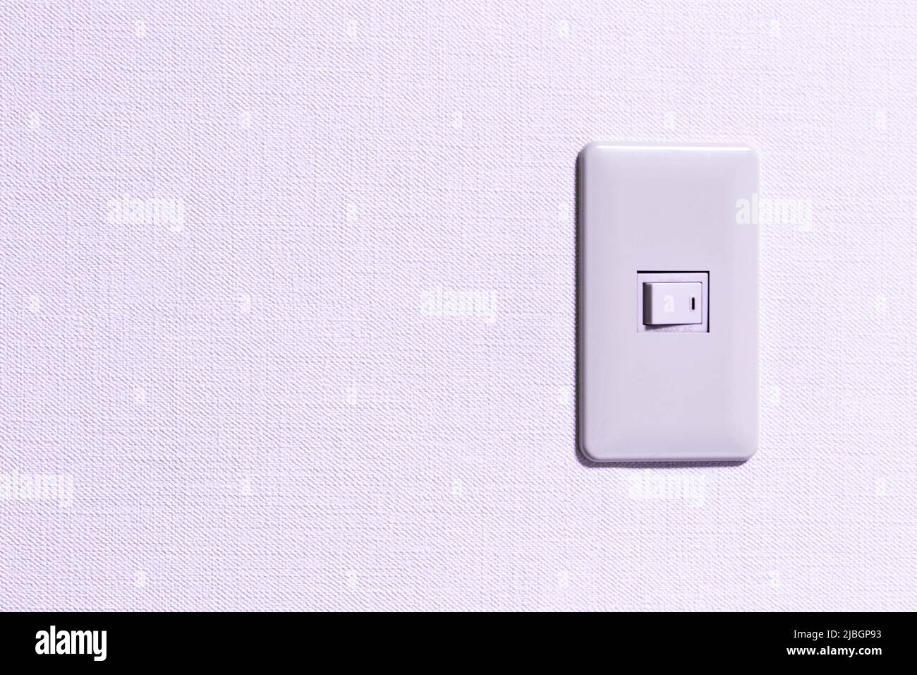 Simple light switch in room which is installed on the white coloured ...