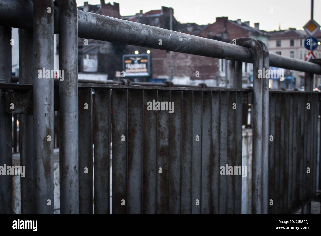 The close up of rusty iron bar fence with grain in blurred background ...