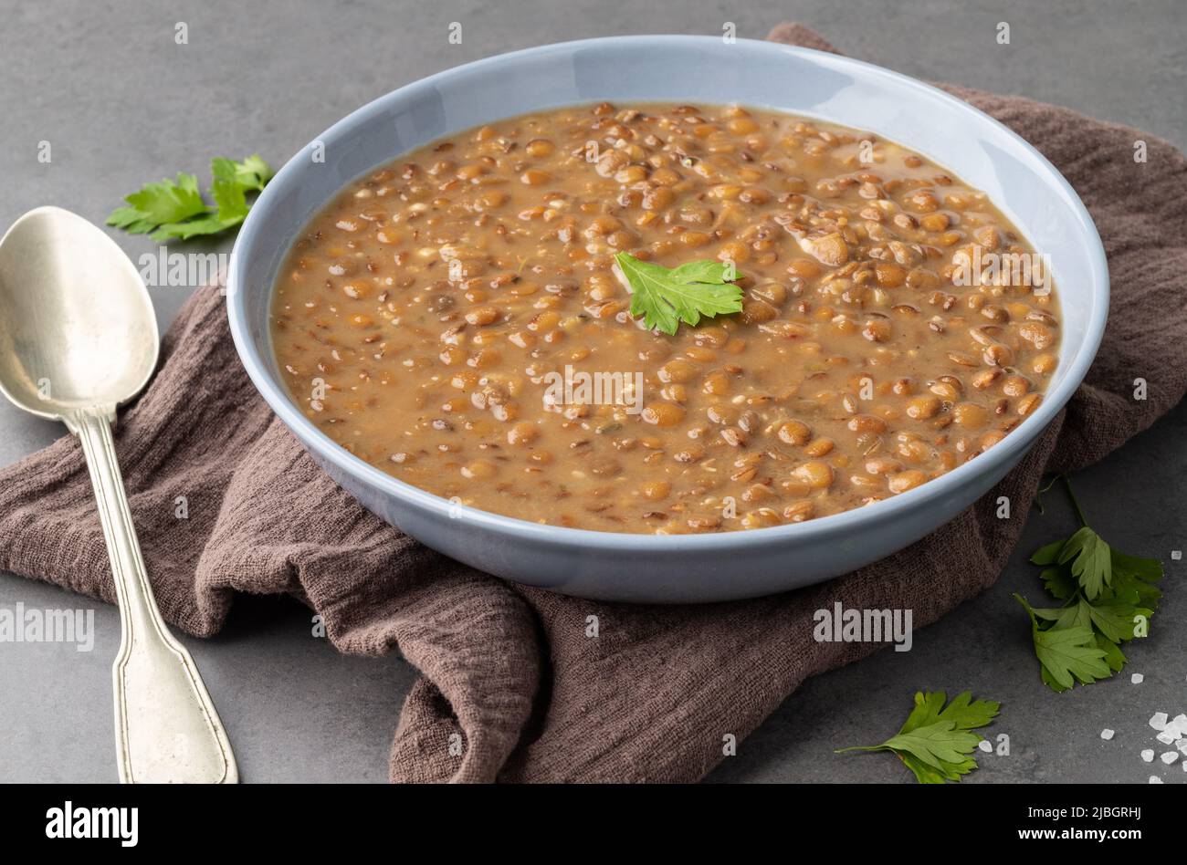 Lentil soup in a bowl with seasoning over stone background Stock Photo ...