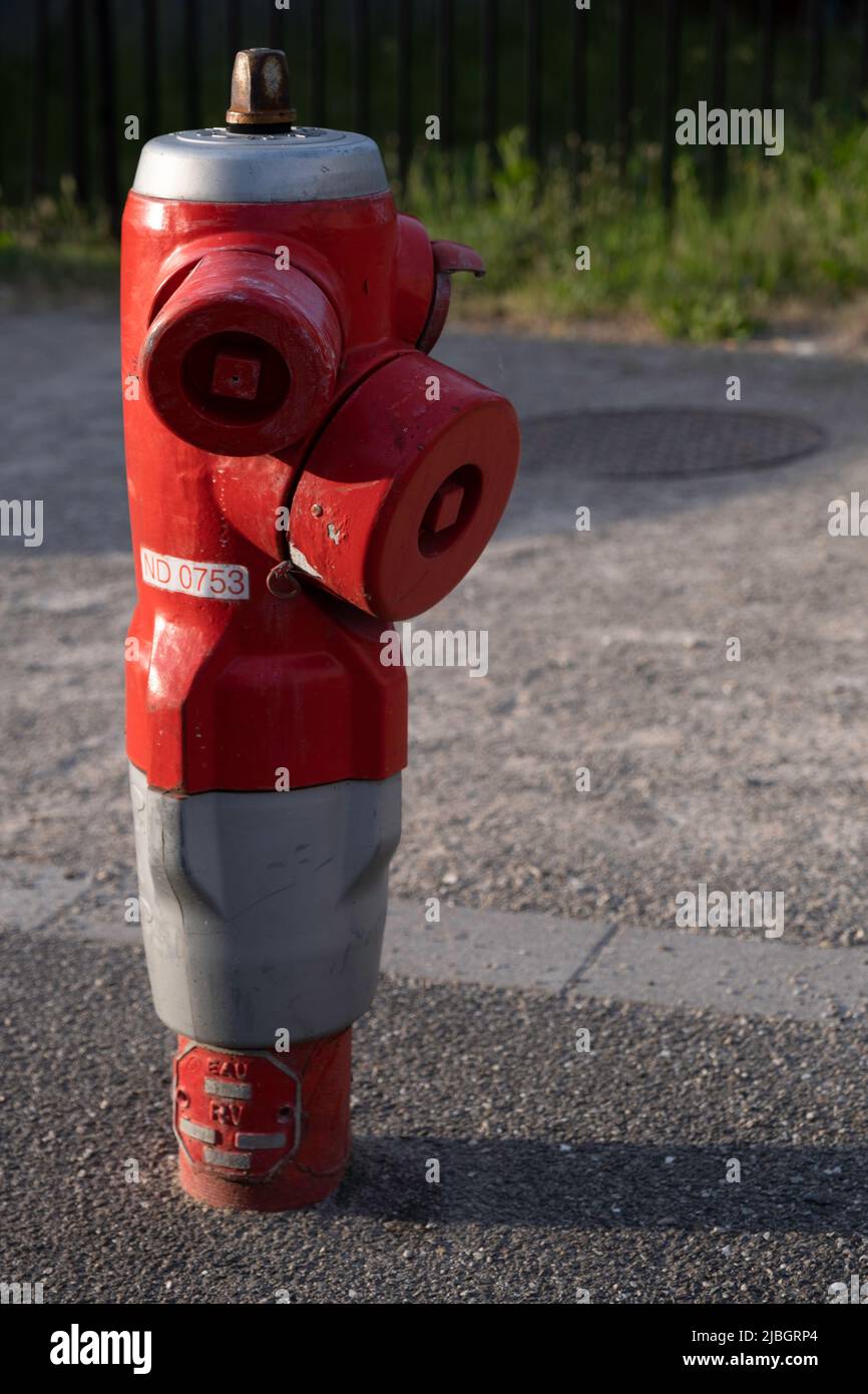 Red fire hydrant on the side of an asphalt road Stock Photo - Alamy