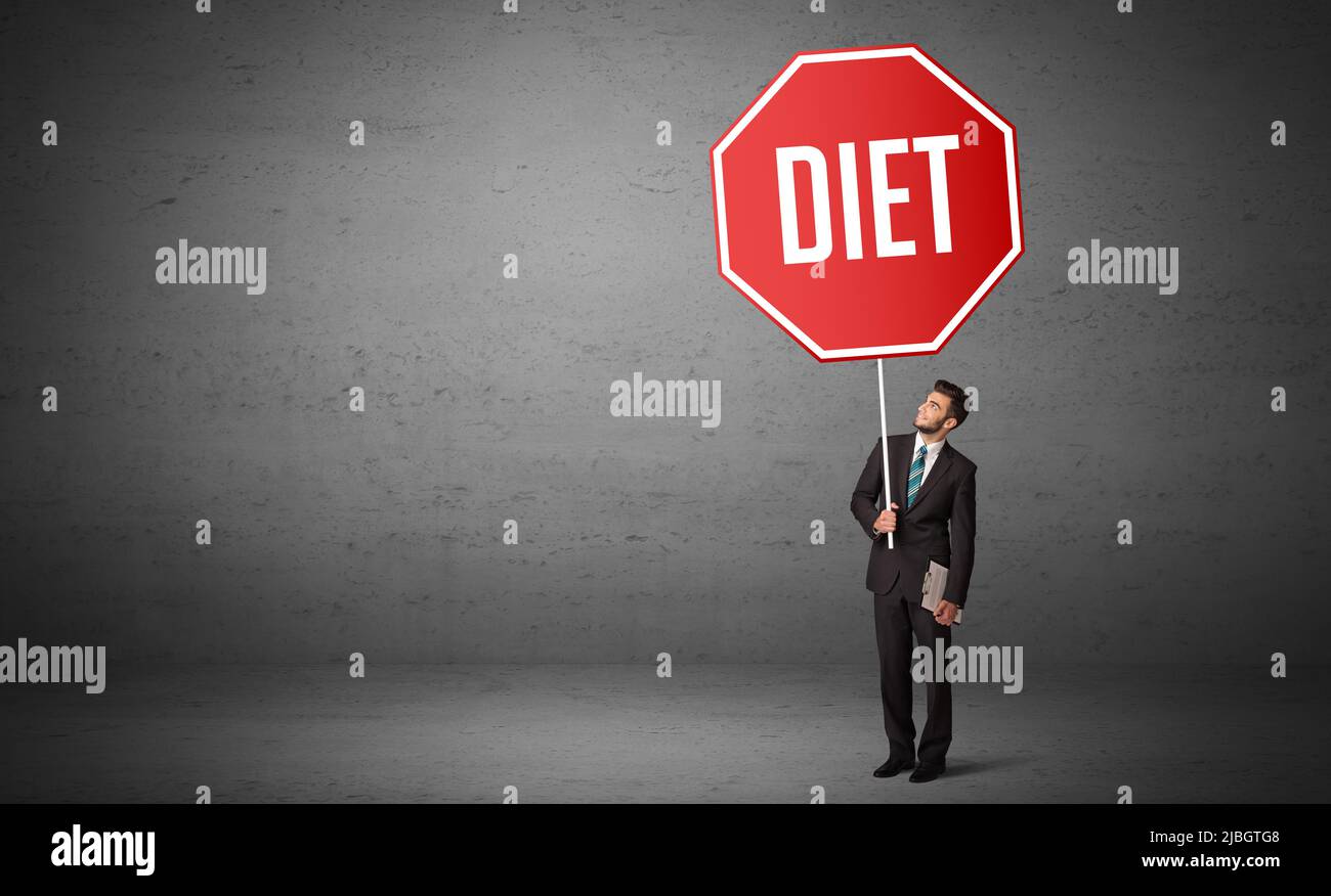 Young business person holding road sign Stock Photo - Alamy