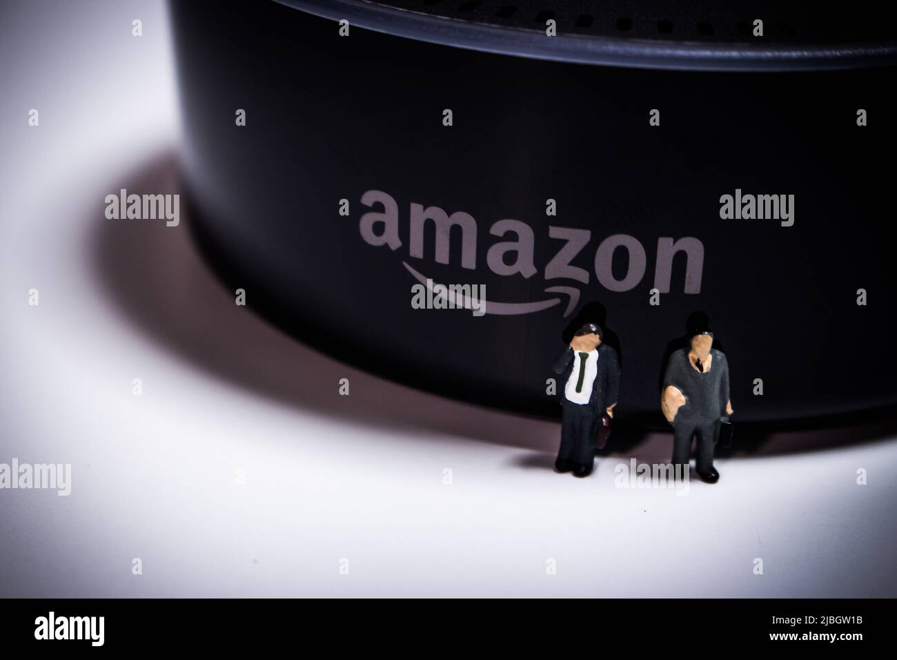 Miniature people businessmen standing in front of Amazon Echo Dot ...