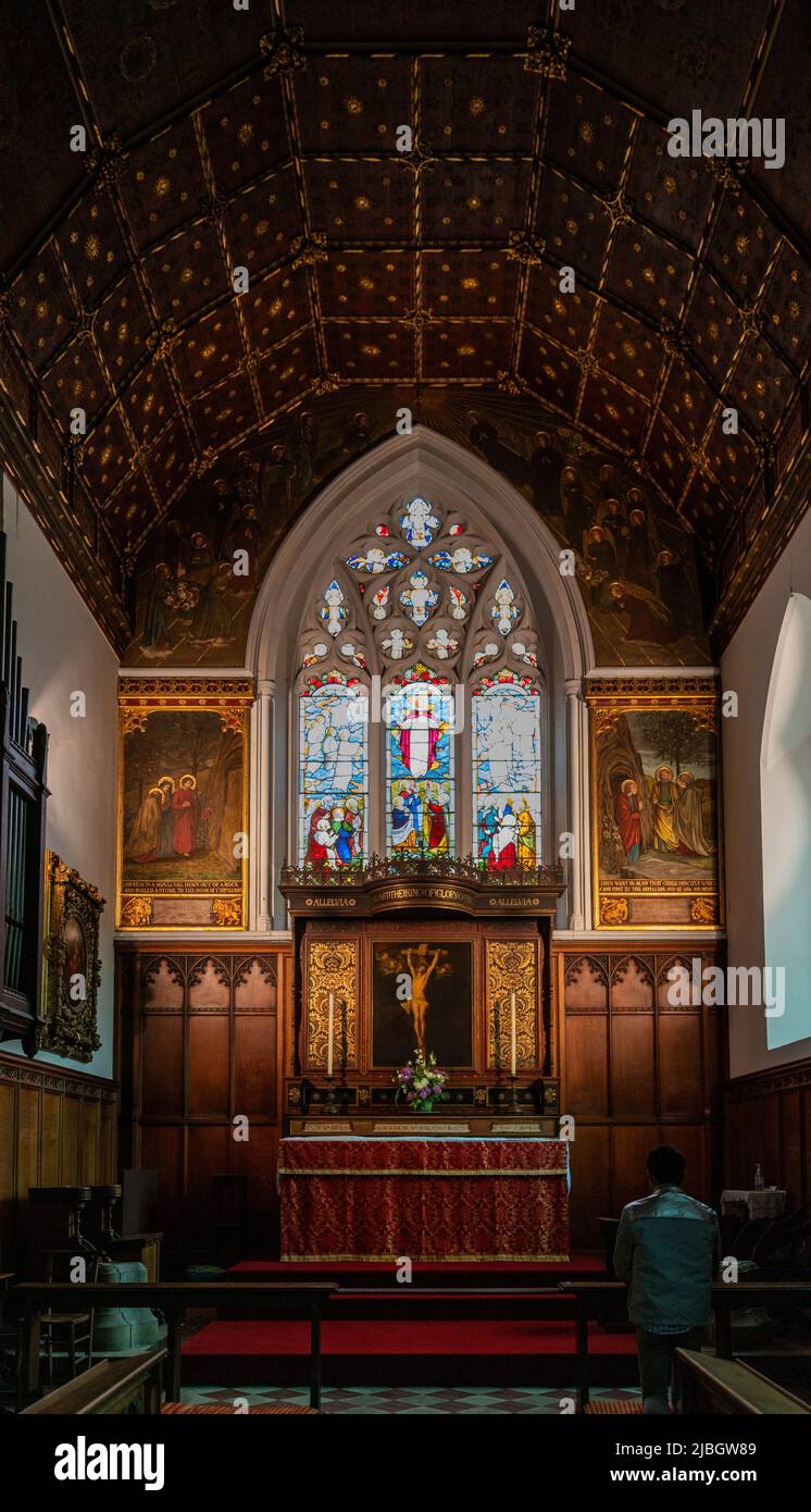 The ornate chancel with beautiful stained-glass windows and ornately ...