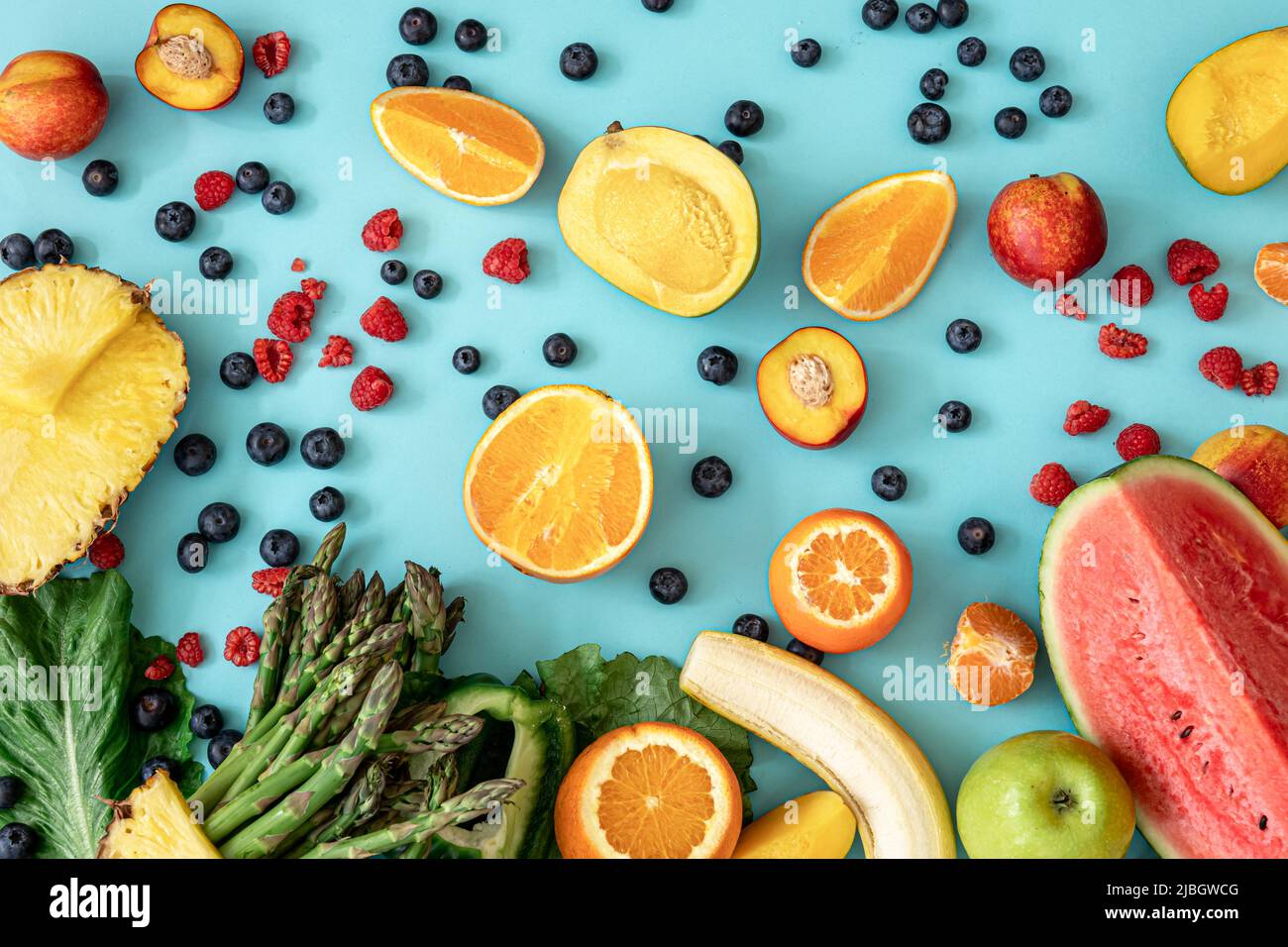 Fruits, berries and vegetables on a blue background Stock Photo - Alamy
