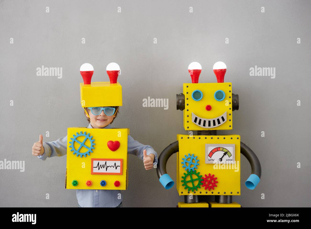 Happy child with robot. Funny kid have an idea. Success, creative and ...