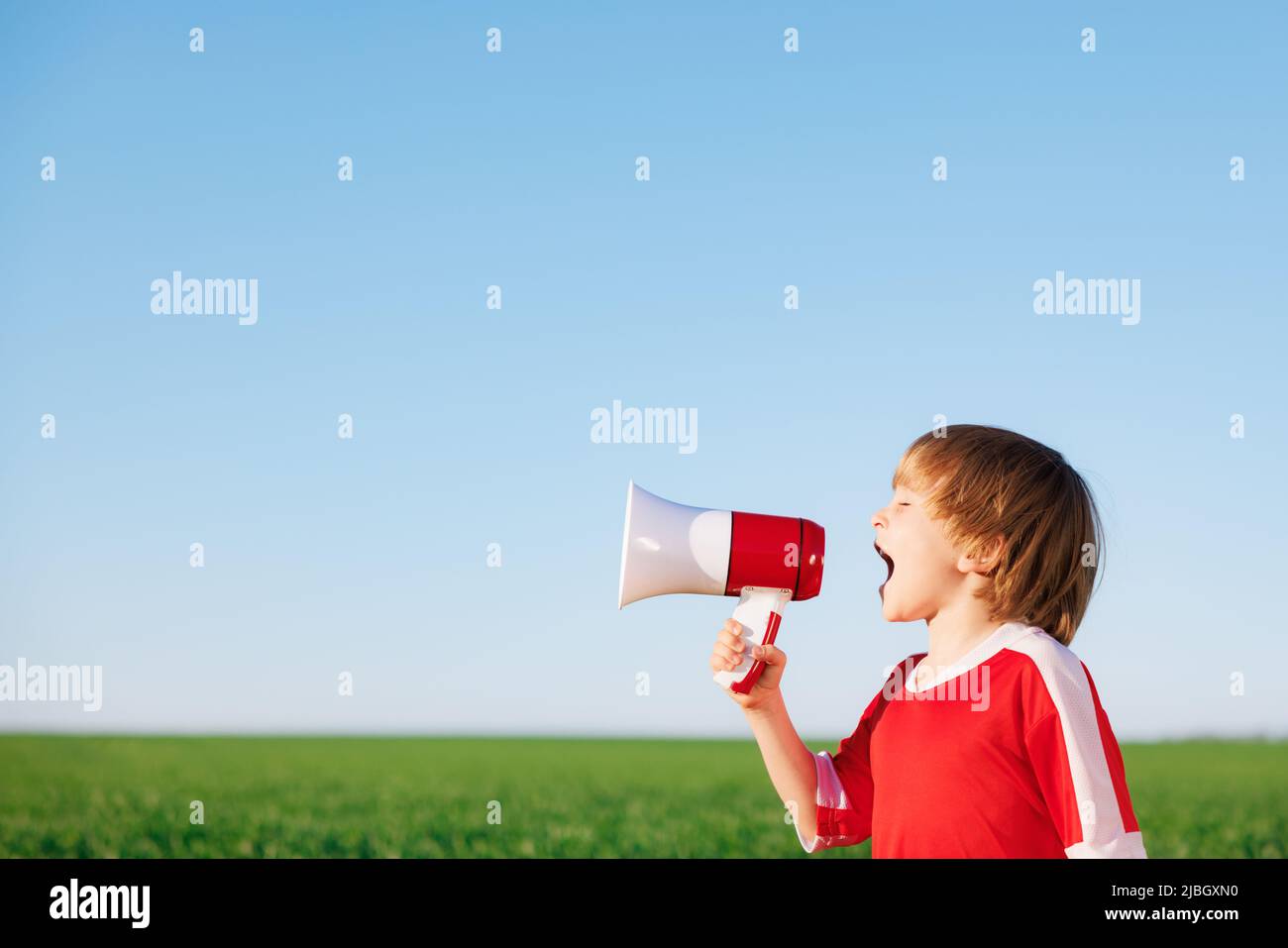 Happy kid pretend to be a soccer player. Portrait of child outdoor. Boy ...