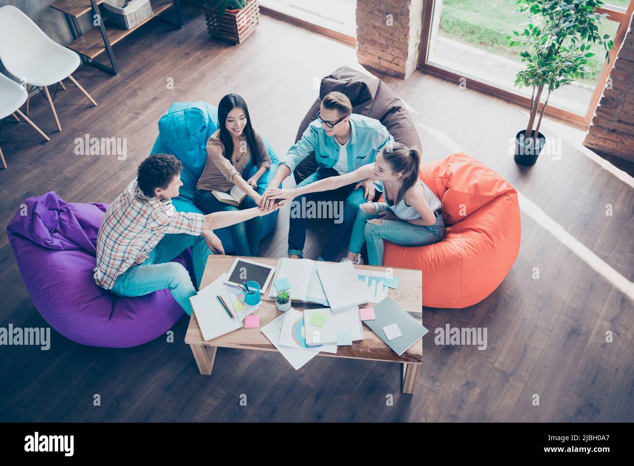 Top angle view photo of funky friendly workers group sitting dorm arms ...