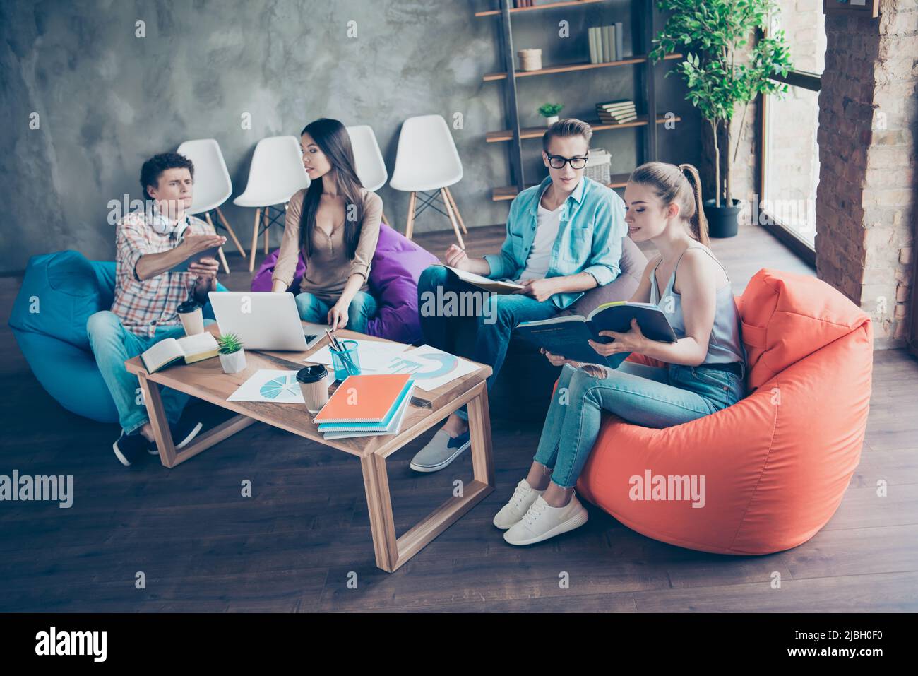 Photo of intelligent college students studying together discuss ...