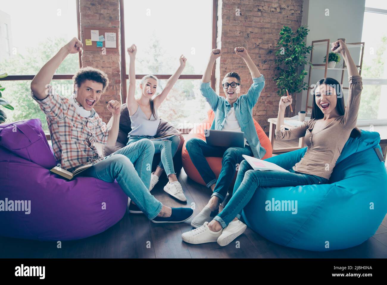 Photo of funny lucky workers group sitting dorm starting new project ...