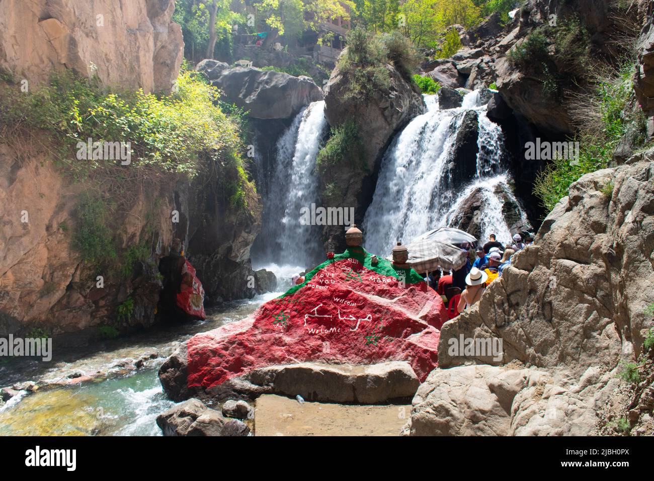 Marrakesh waterfall tourist destination with welcome writting mountain ...