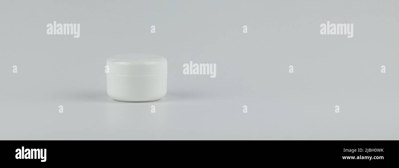 Skincare and cosmetology banner mockup. Unbranded white plastic jar for ...