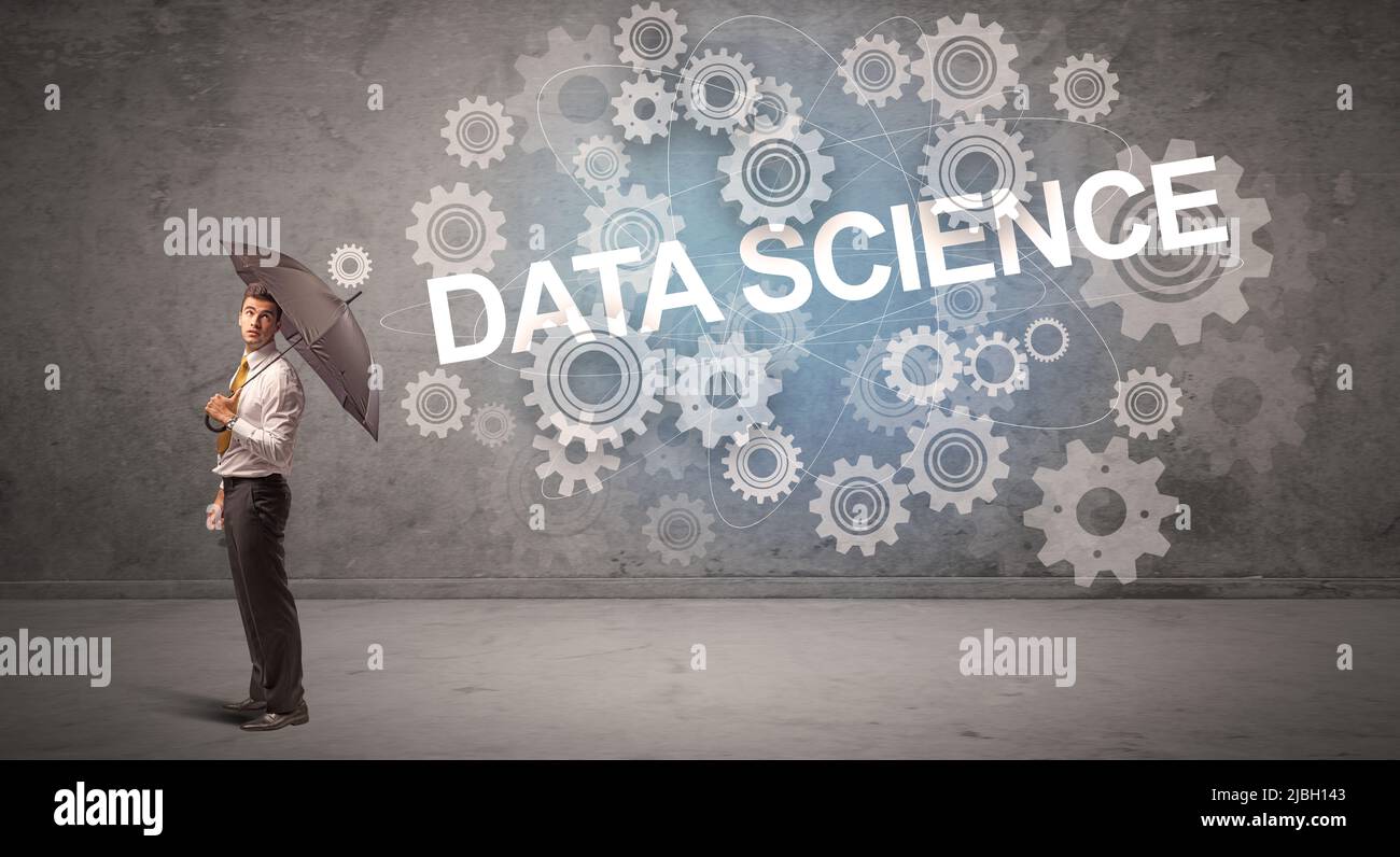 Businessman defending with umbrella concept Stock Photo - Alamy