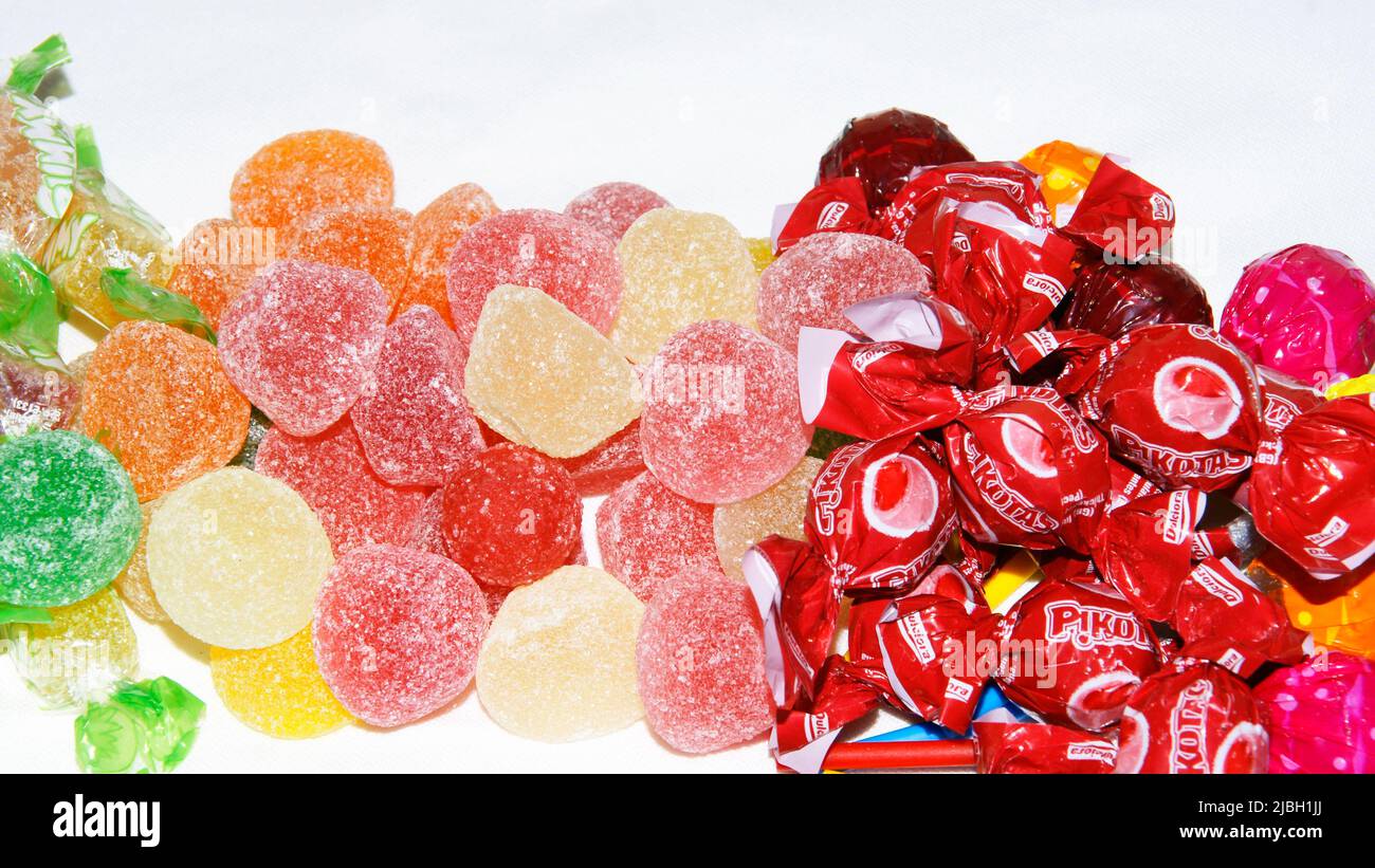 Candies of various shapes and colors on white background Stock Photo ...