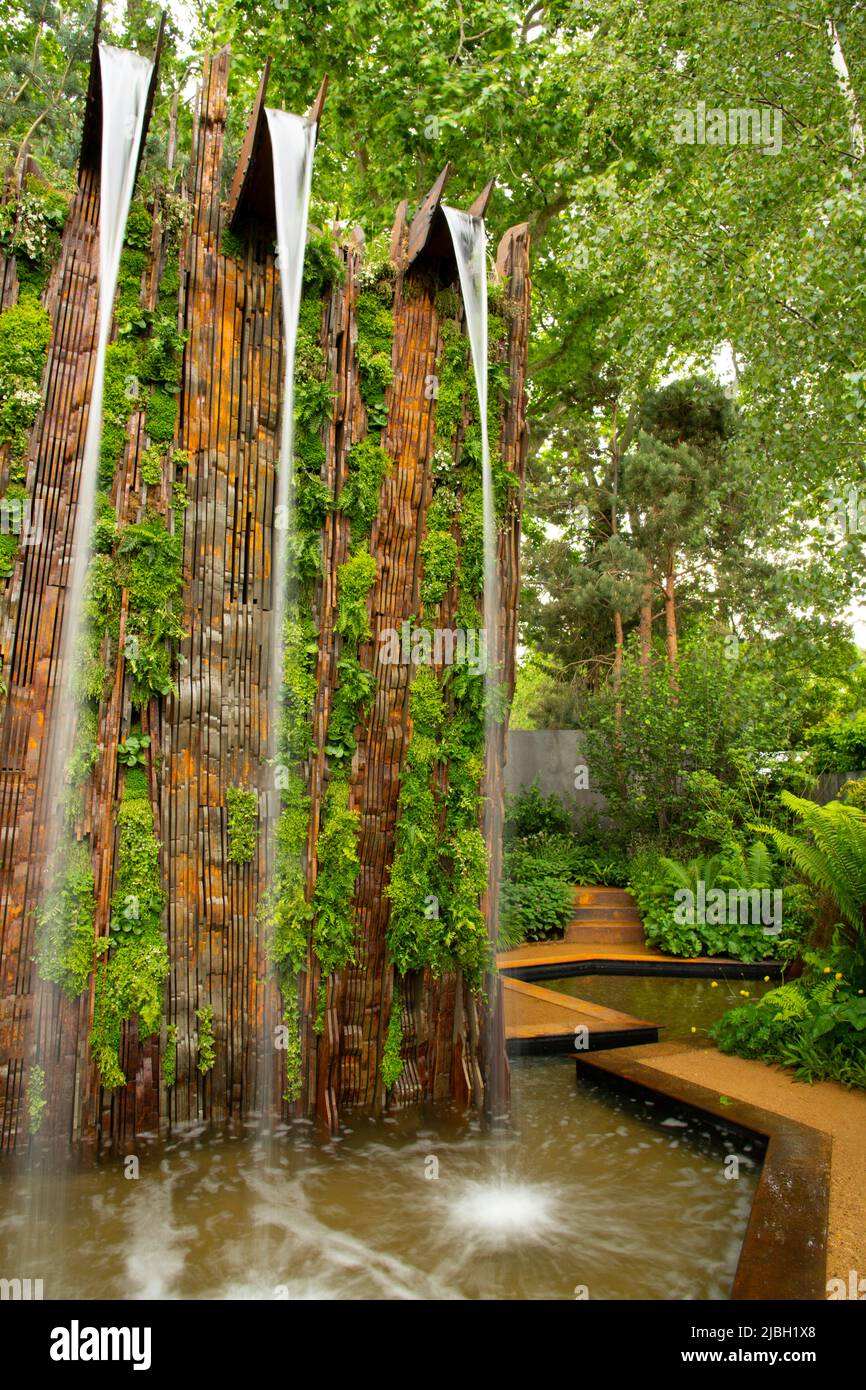 A cascade of water over wood panel made to look like a striated rock ...