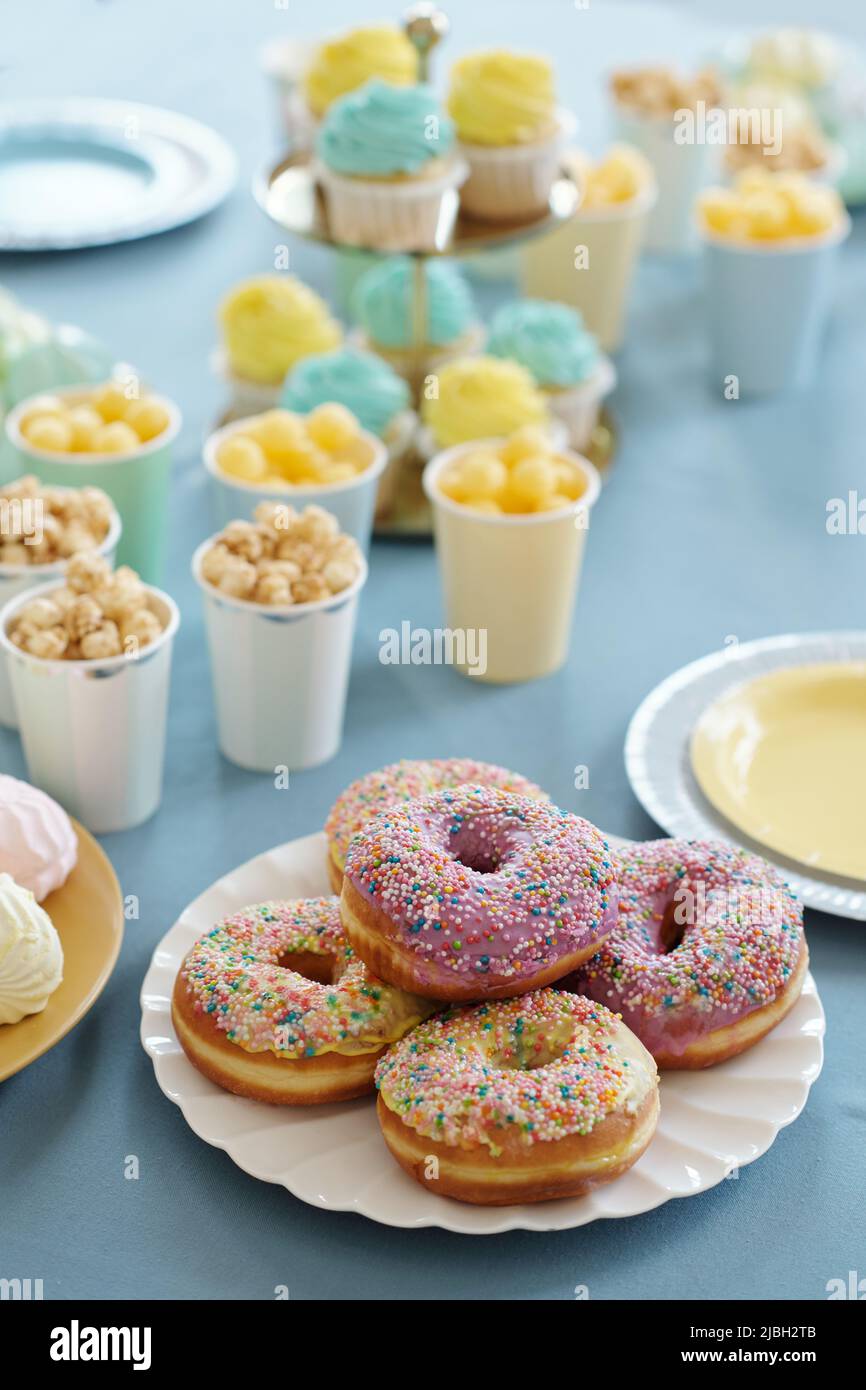 High angle view of candy bar with glazed baked donuts, cakes, sweets on ...