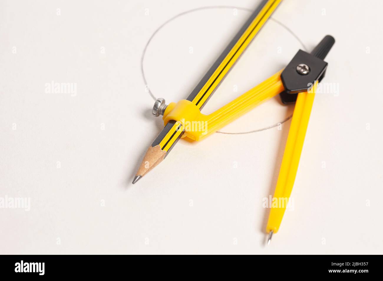 Yellow compass with pencil isolated on white background Stock Photo - Alamy