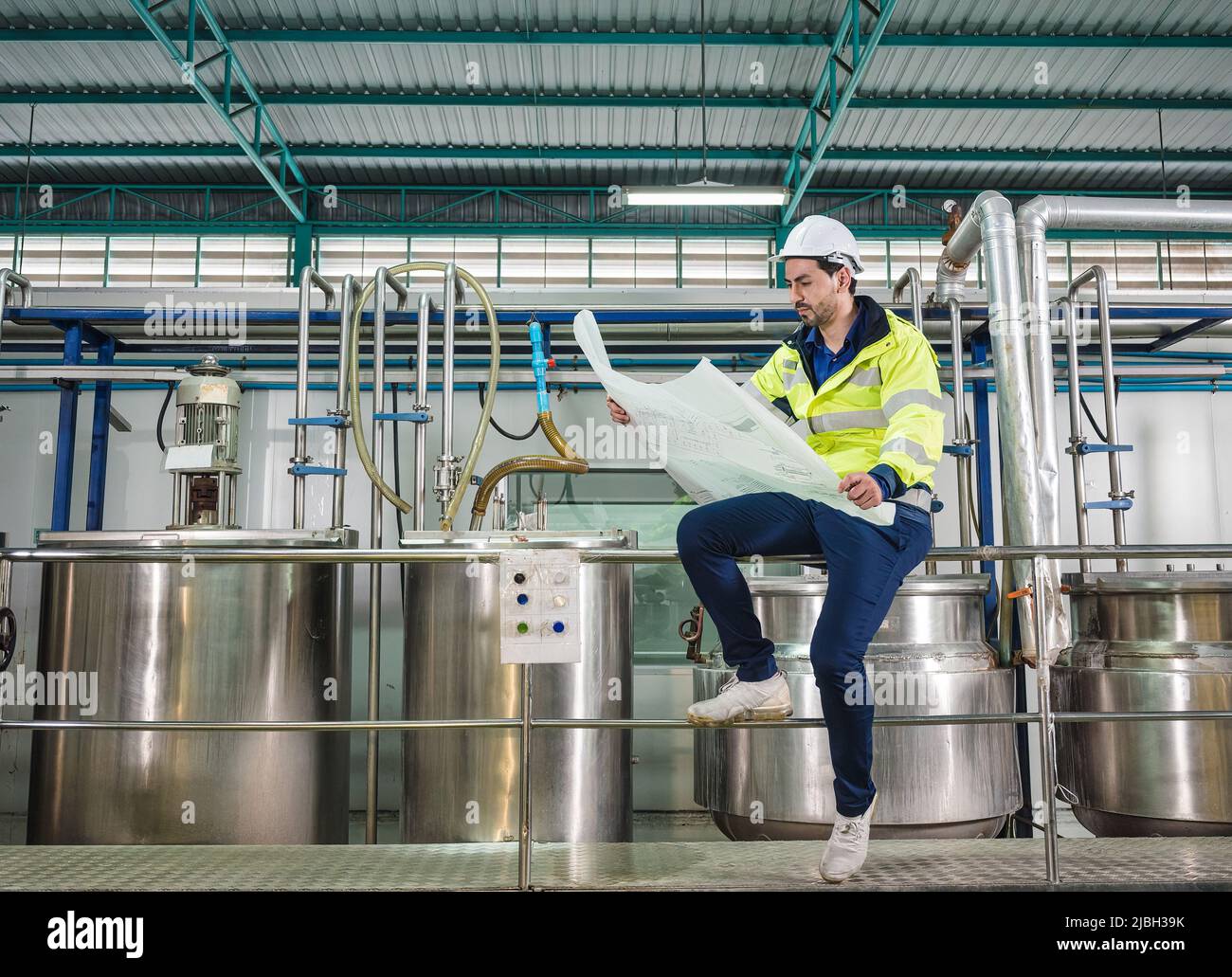 Caucasian technician engineer man in uniform sitting and holding ...