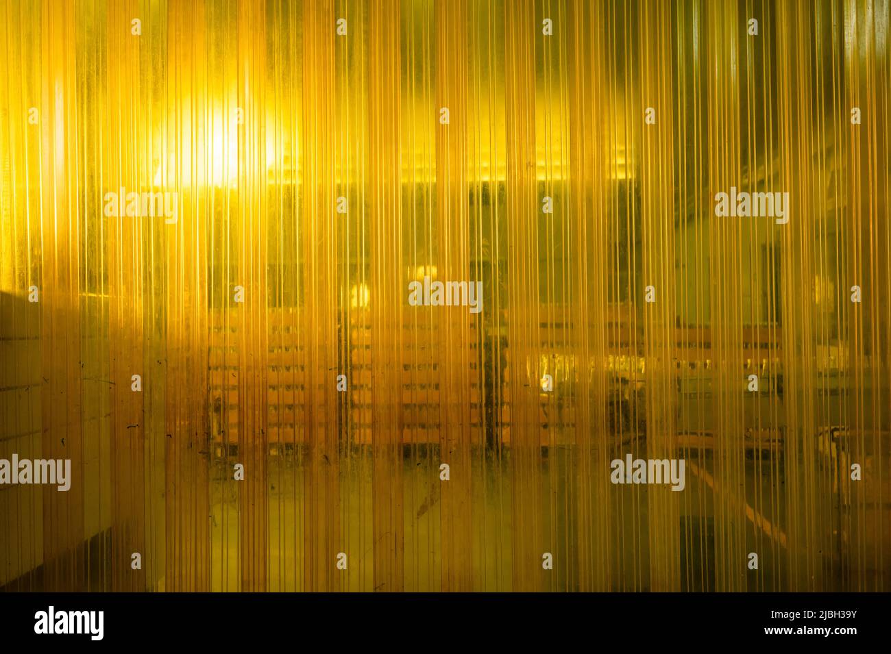 Yellow PVC plastic partition entrance in warehouse at processing plant ...