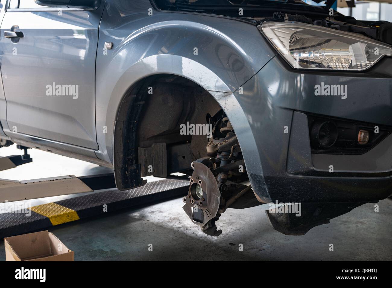 Repair and change parts a pickup truck with damaged axle and wheel ...