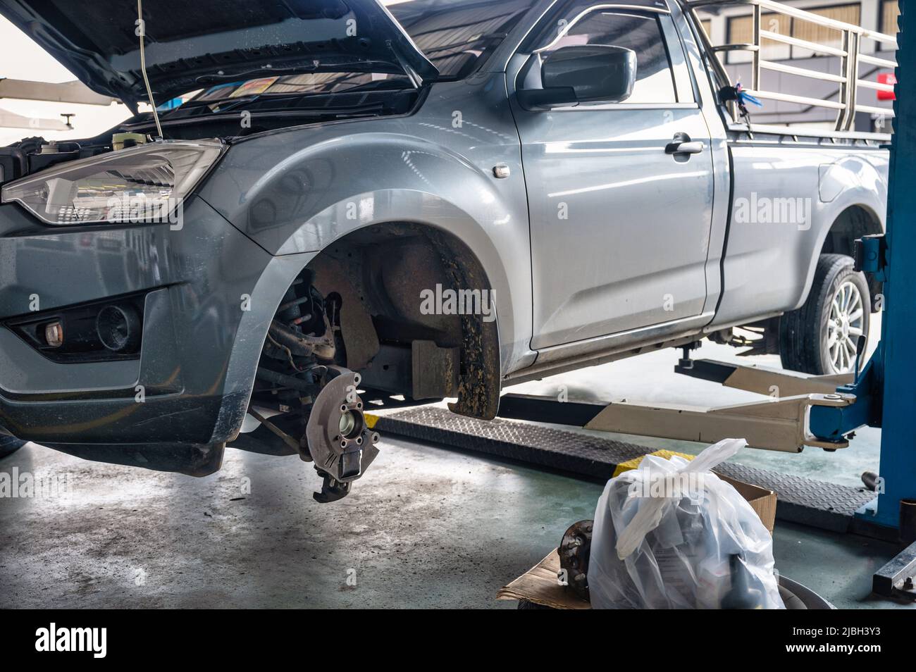 Repair and change parts a pickup truck with damaged axle and wheel ...