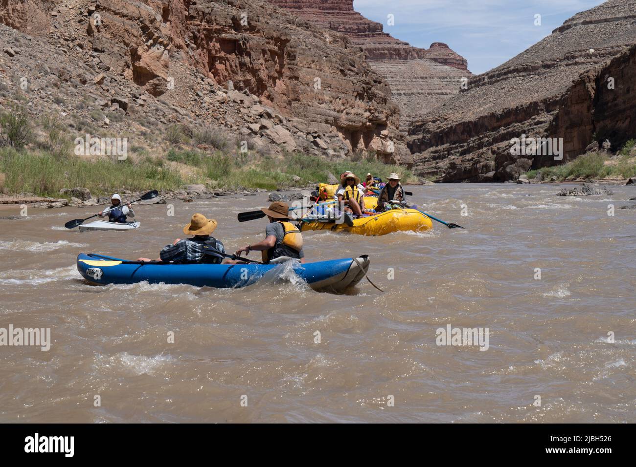 River explorers and tourists navigate their boats, rafts, paddle boards ...
