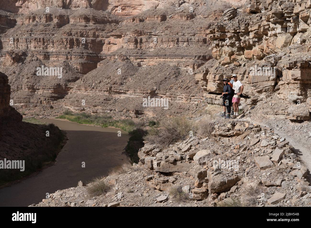 River explorers and tourists climb the steep walls along the San Juan ...