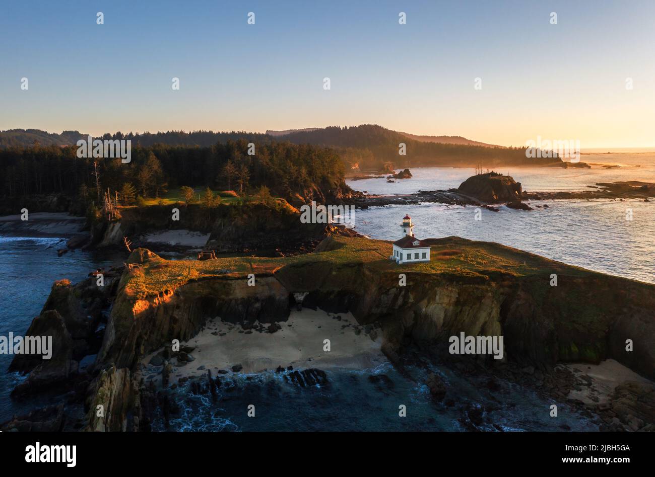 Cape Arago Lighthouse at the Oregon Coast at sunset. Also seen are ...