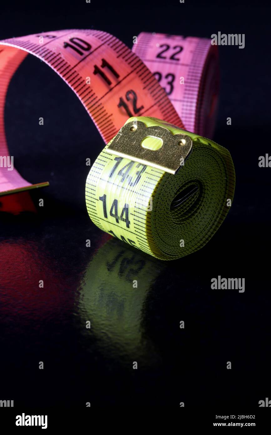 measuring tape on a black background Stock Photo - Alamy