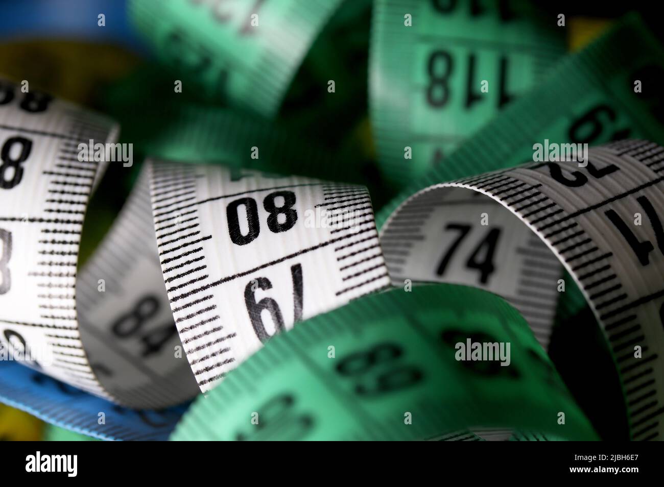 measuring tape on a black background Stock Photo - Alamy