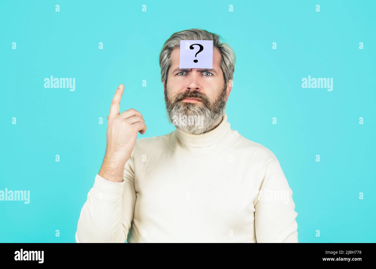 Thinking bearded man with question mark on blue background. Paper notes ...