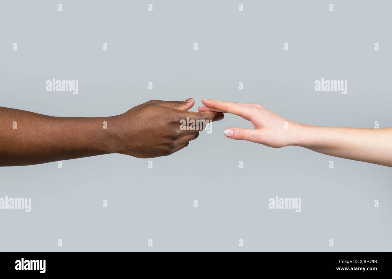 Hand skin colors touch two. Woman and African American man touching ...