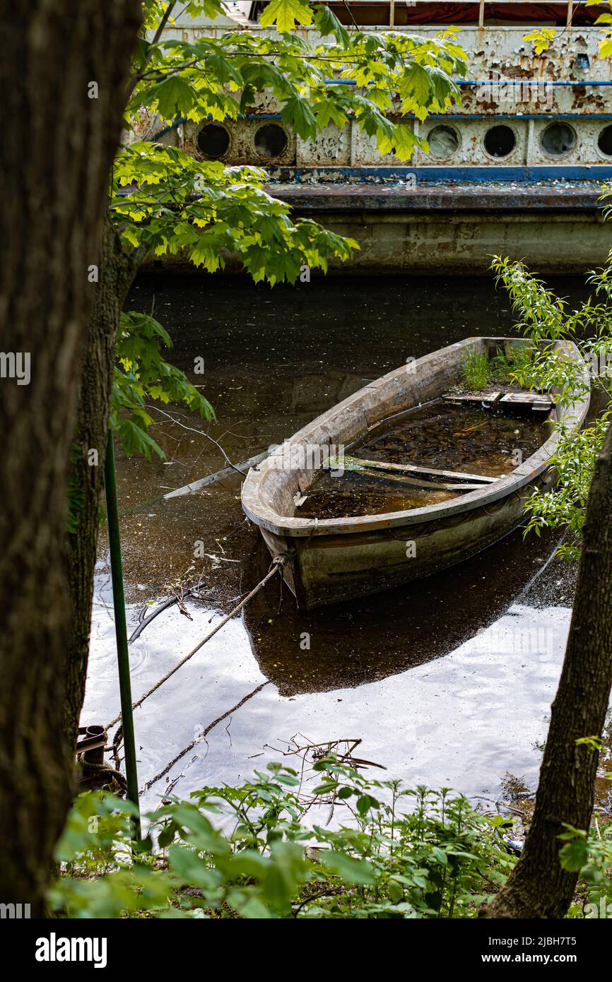 old rotten sunken boat tied to the shore Stock Photo - Alamy