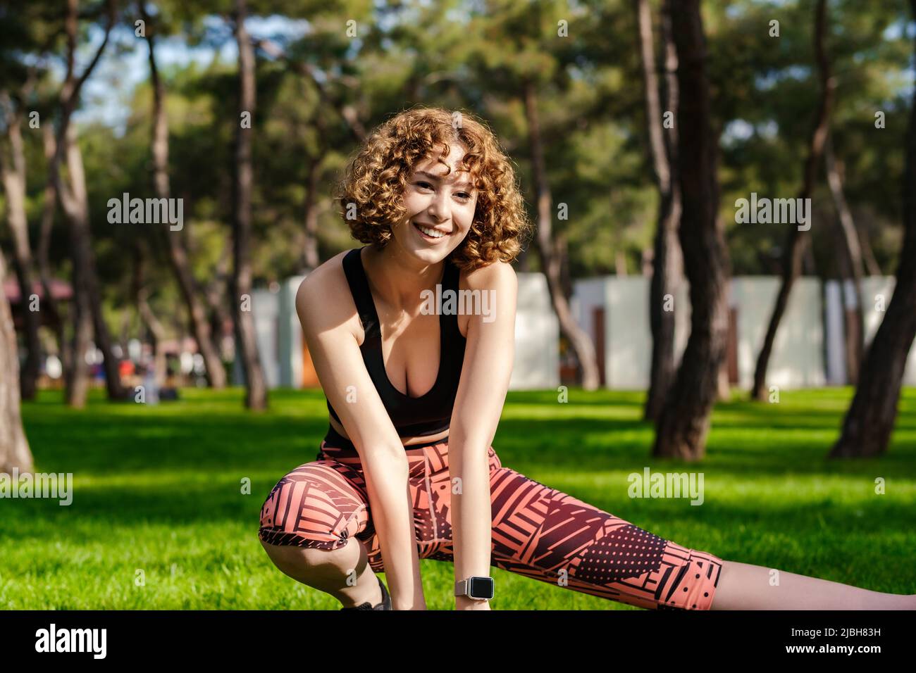 Cute sportive woman wearing sportive clothes on city park, outdoors ...