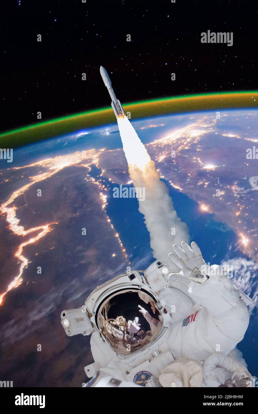 Astronaut waving to the camera on a spacewalk.. Space scene. The ...