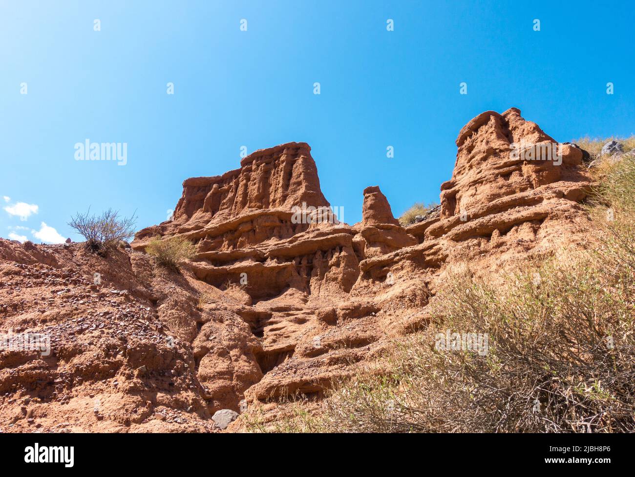 Red tales from clay. Issyk-Kul region in Kyrgyzstan. Beautiful mountain ...