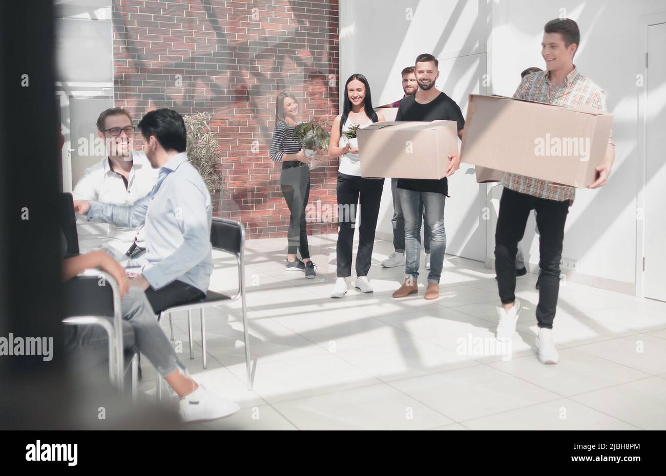 creative business team brings cardboard boxes to the new office Stock ...