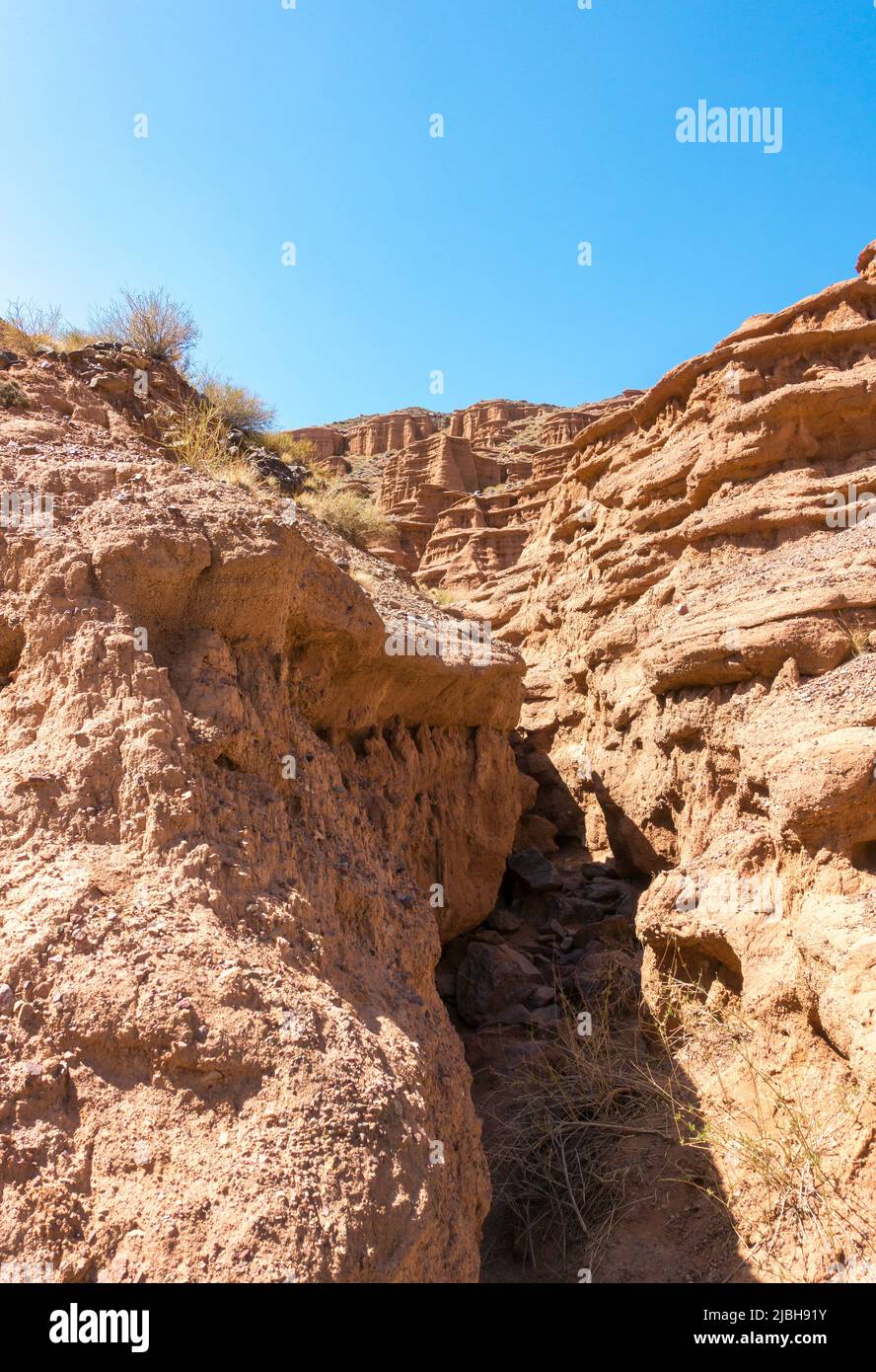 Red rocks and a passage between rocks. Clay canyons. Issyk-Kul region ...