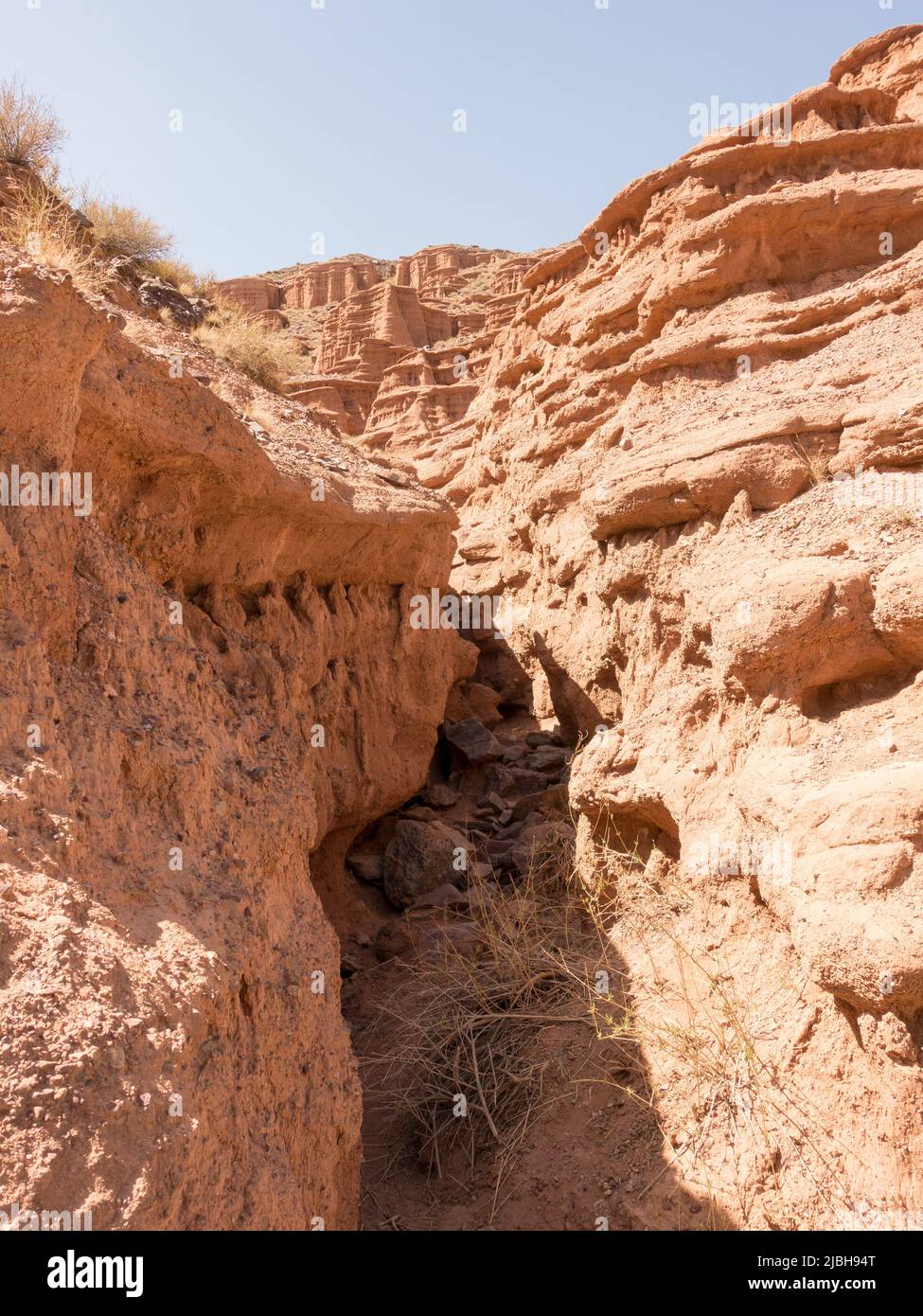 Red rocks and a passage between rocks. Clay canyons. Issyk-Kul region ...