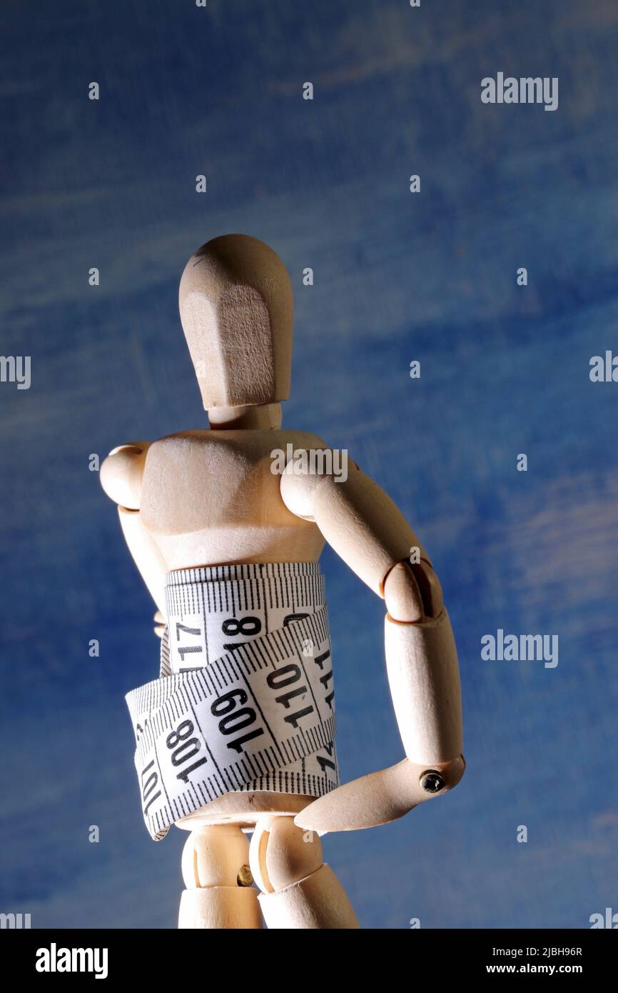Wooden mannequin with measuring tape Stock Photo - Alamy