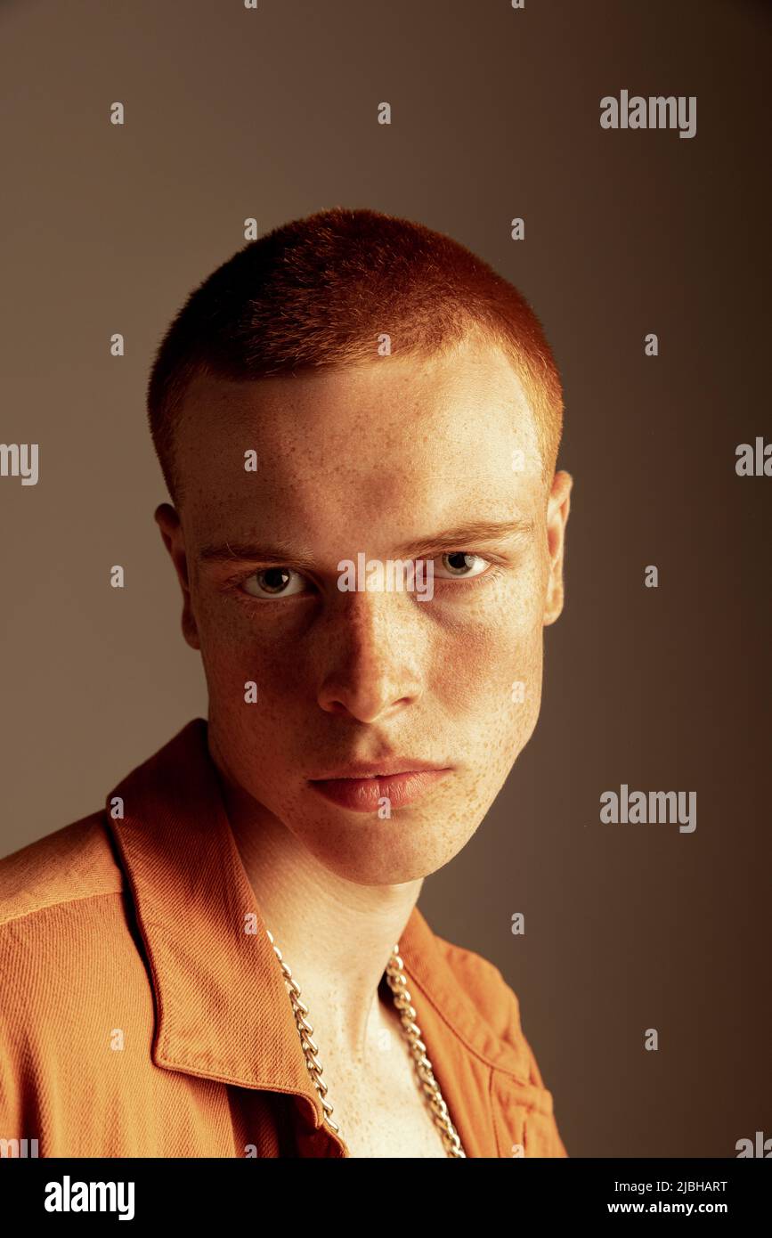 Close-up portrait of handsome red-haired young man with freckles ...