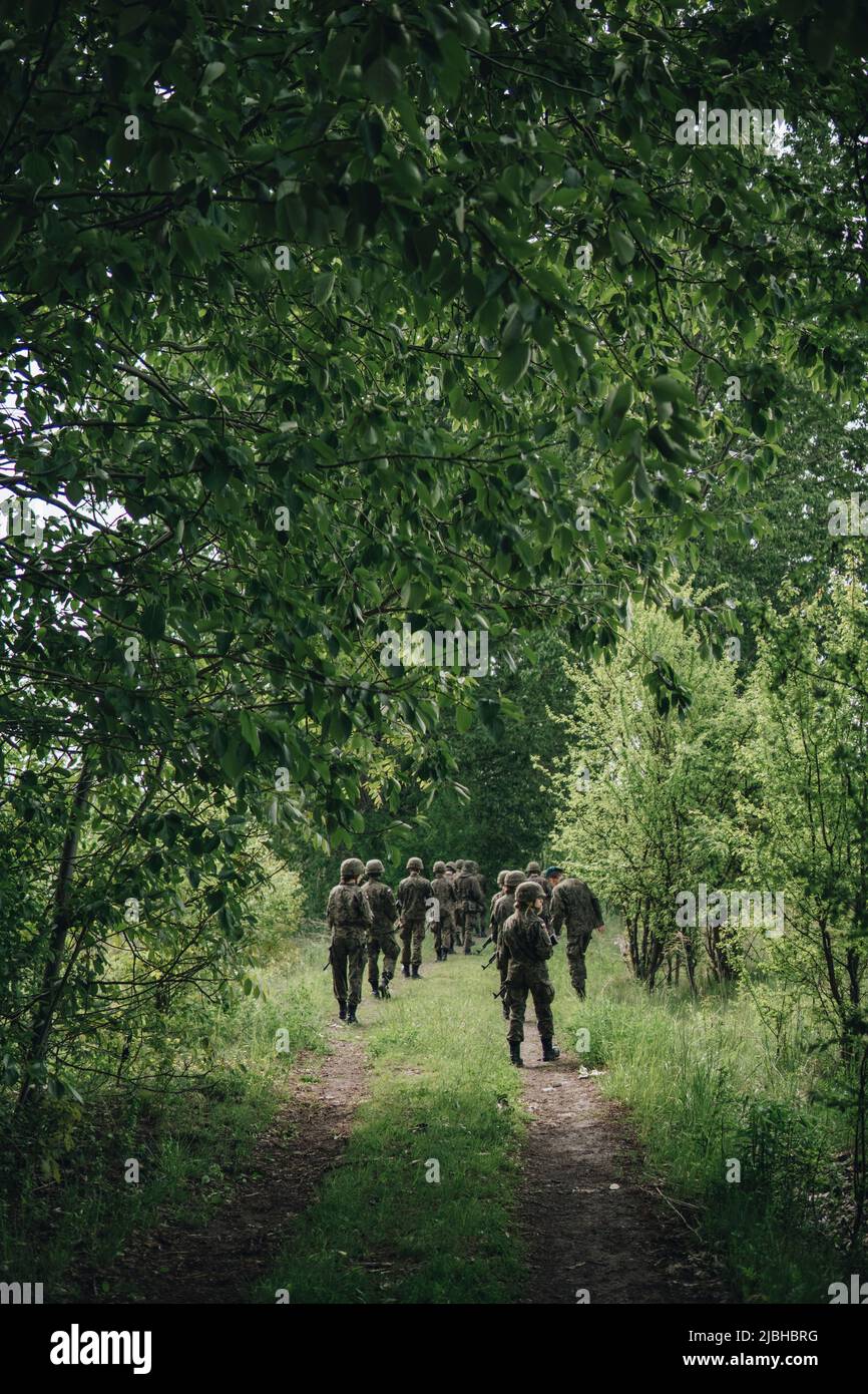 young soldiers patrolling a forest during training Stock Photo - Alamy