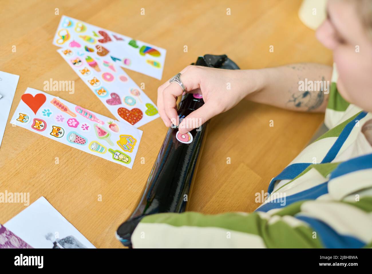 Above view of young female with physical disability putting handmade ...