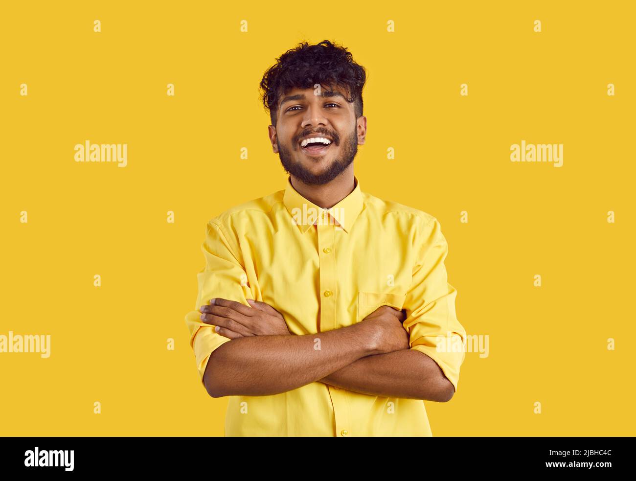 Portrait of smiling indian man isolated on yellow background Stock ...