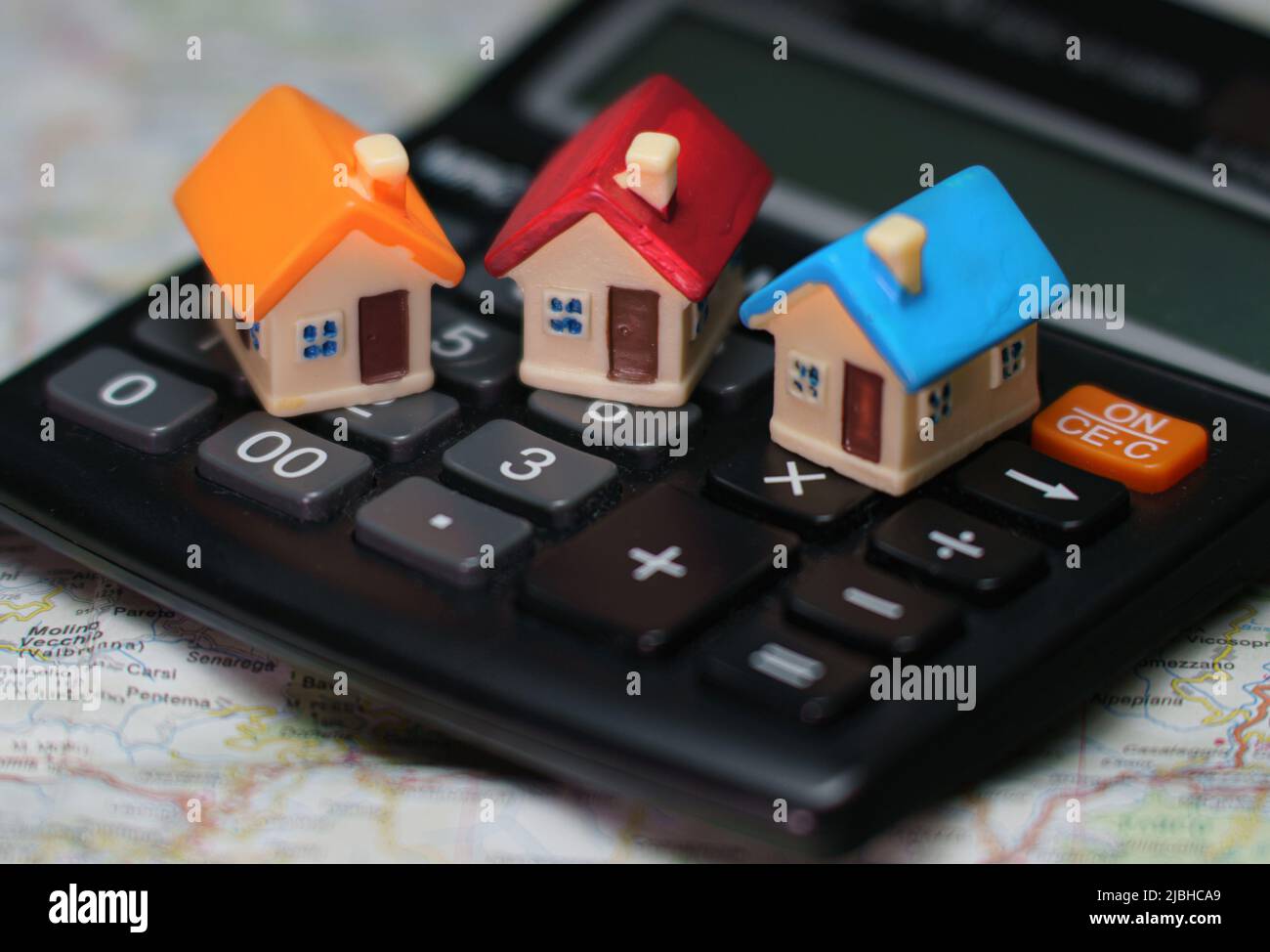 Toy house and calculator. Real estate purchase concept Stock Photo - Alamy