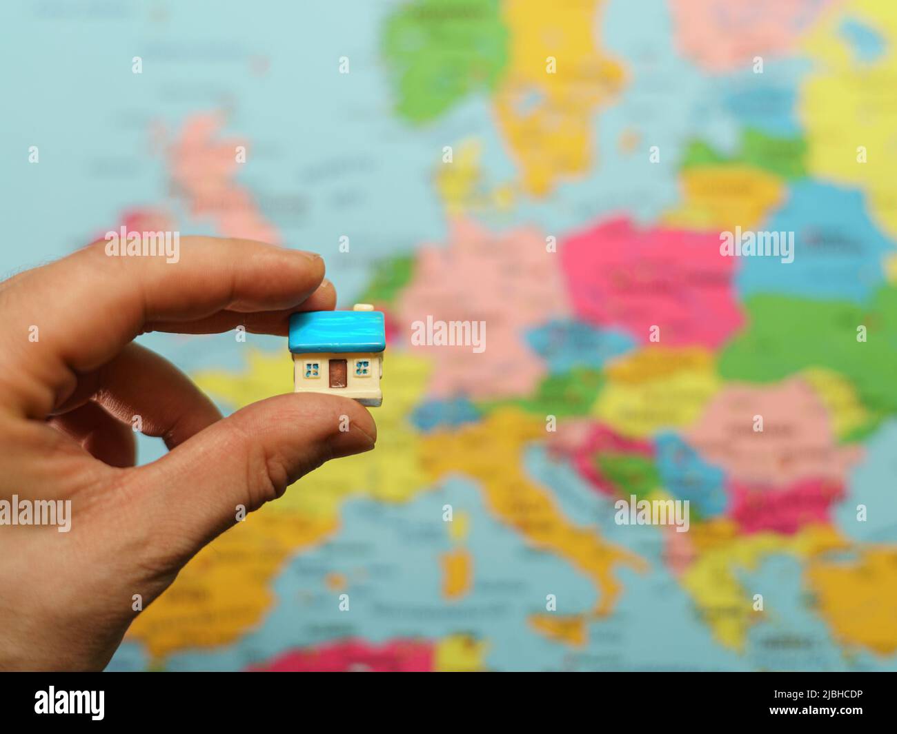 Small toy house in front of Europe map Stock Photo - Alamy