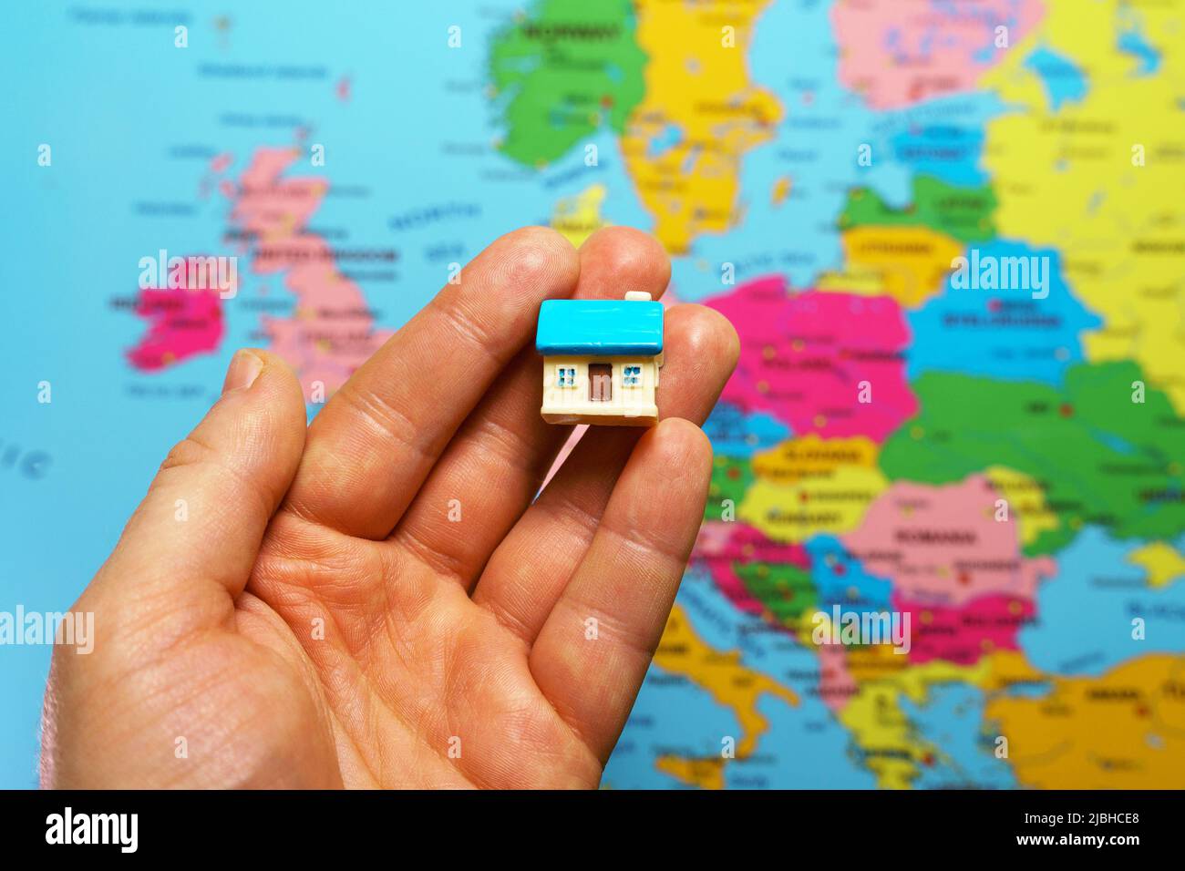 Small toy house in front of Europe map Stock Photo - Alamy