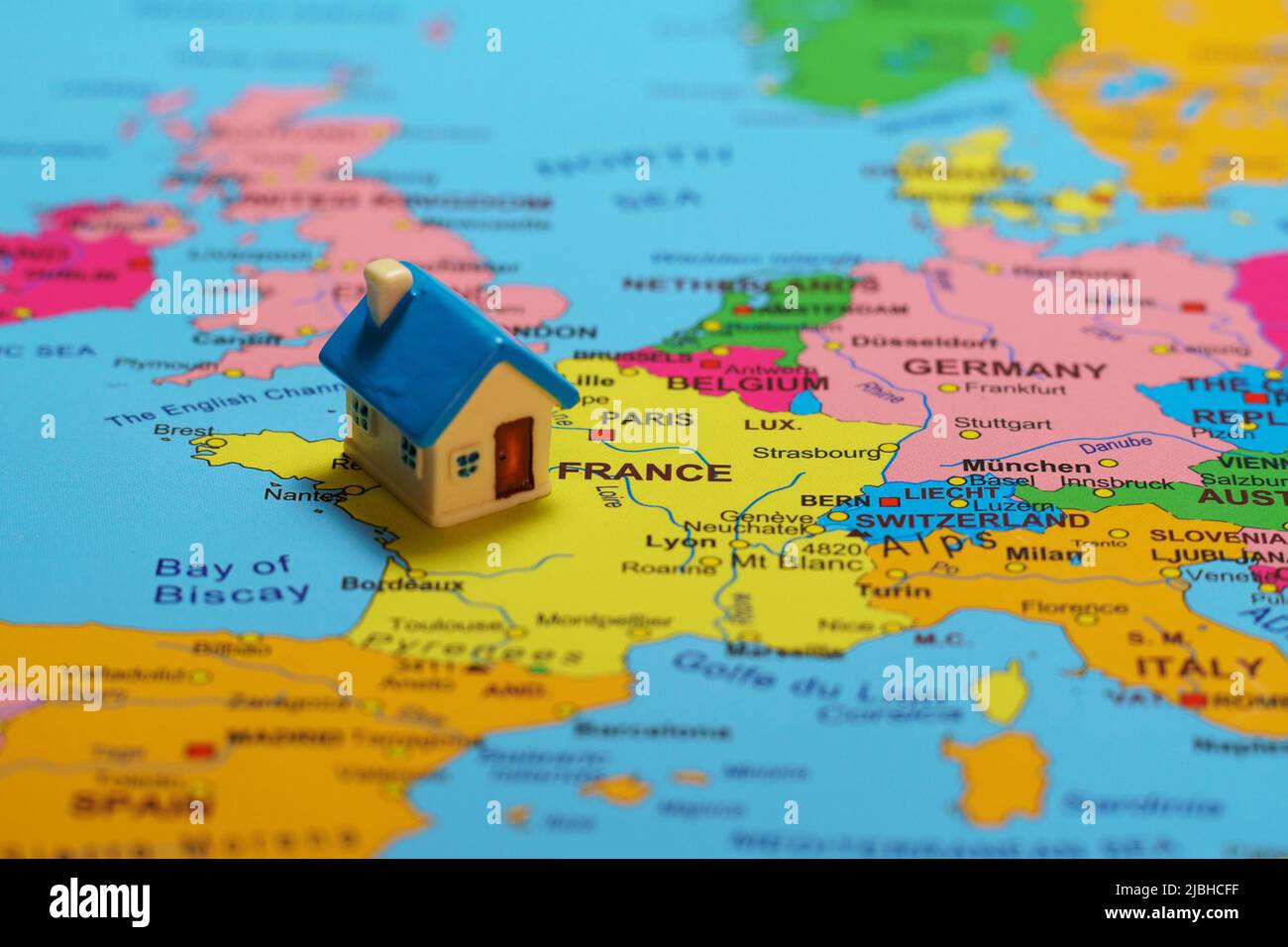 Small toy house on the map of France Stock Photo - Alamy