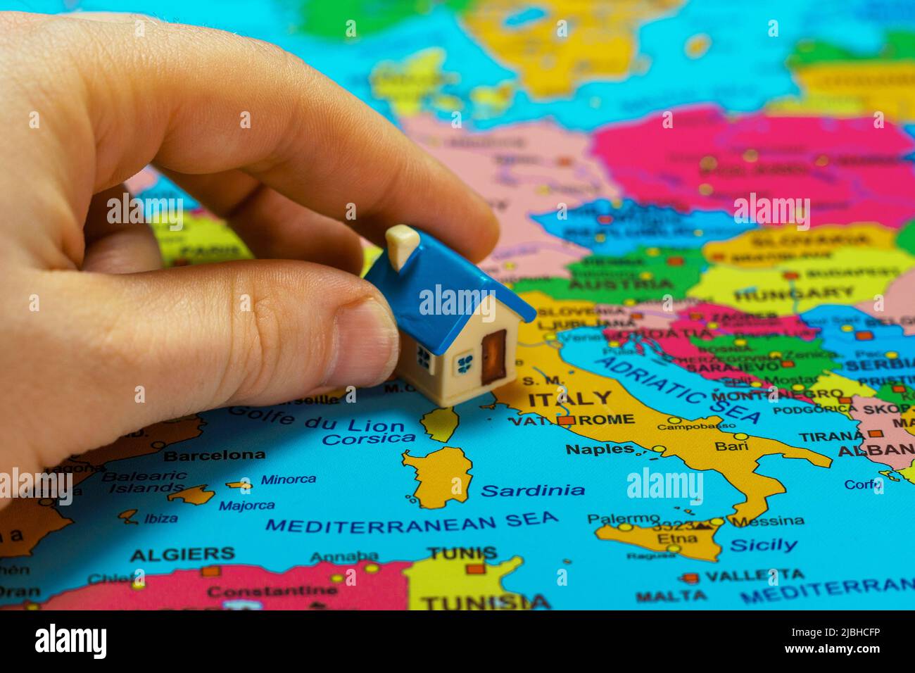 Small toy house on the map of Italy Stock Photo - Alamy
