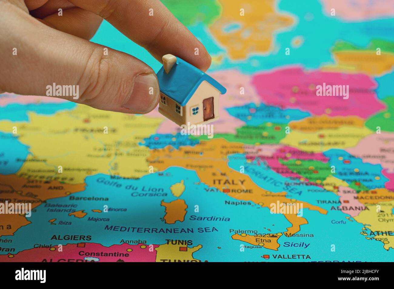 Small toy house on the map of Italy Stock Photo - Alamy