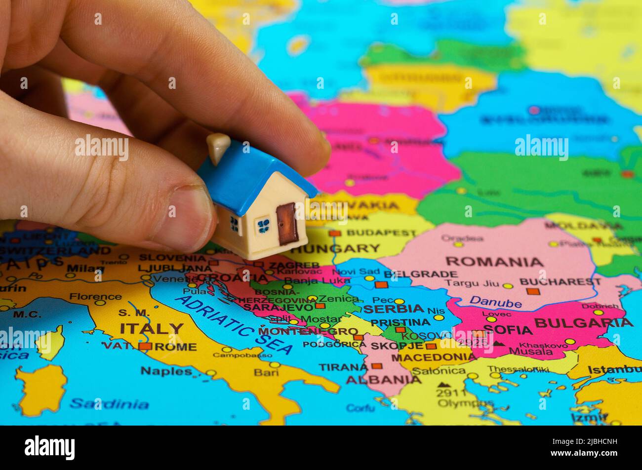 Small toy house on the map of Balkans Stock Photo - Alamy